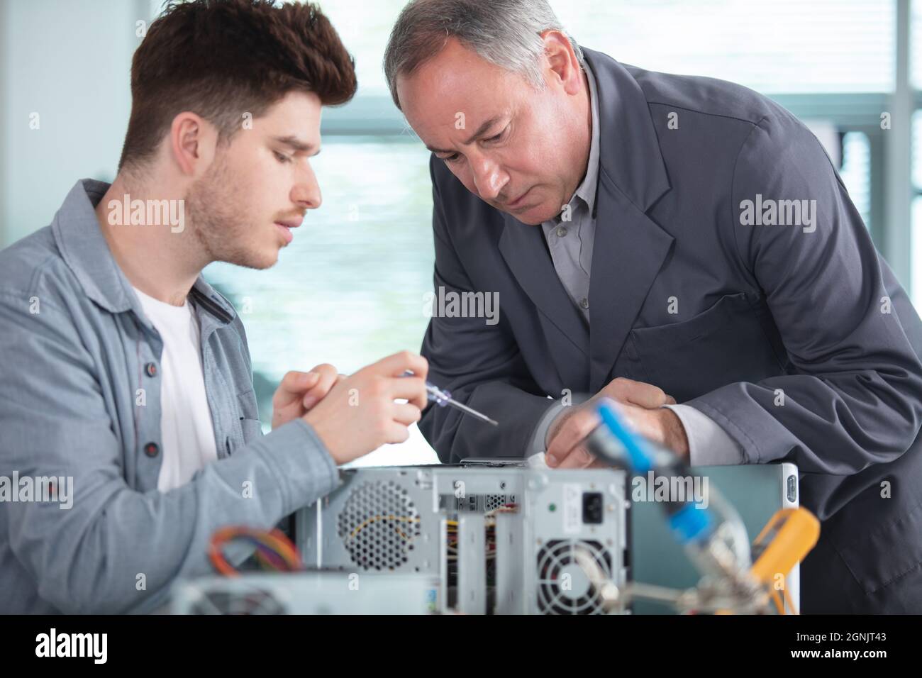 senior boss and his young successful craftsman team Stock Photo - Alamy