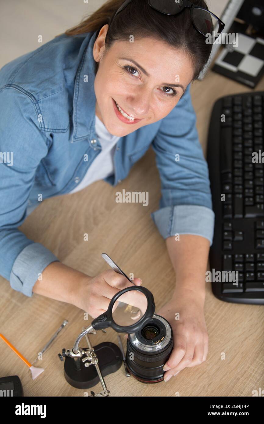 Woman photographer cleaning dirty camera hi-res stock photography and ...