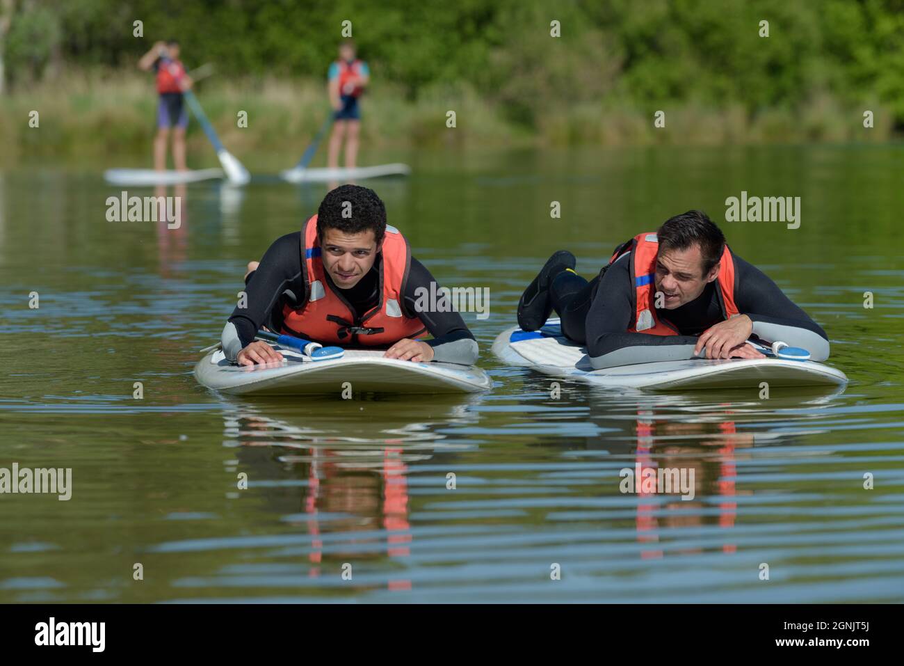 learning to row on the stand-up paddleboard Stock Photo - Alamy