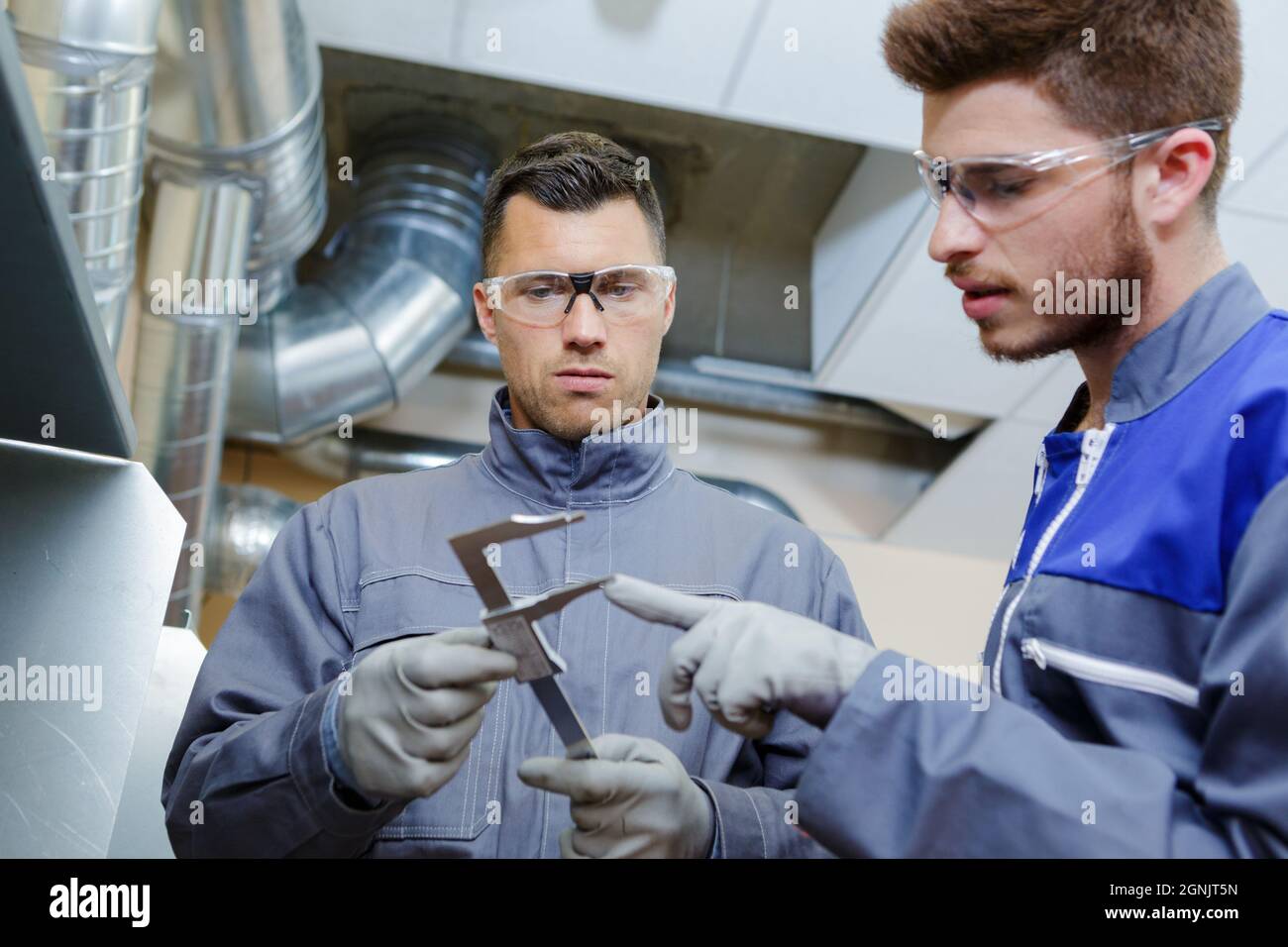Two men checking metal hi-res stock photography and images - Alamy