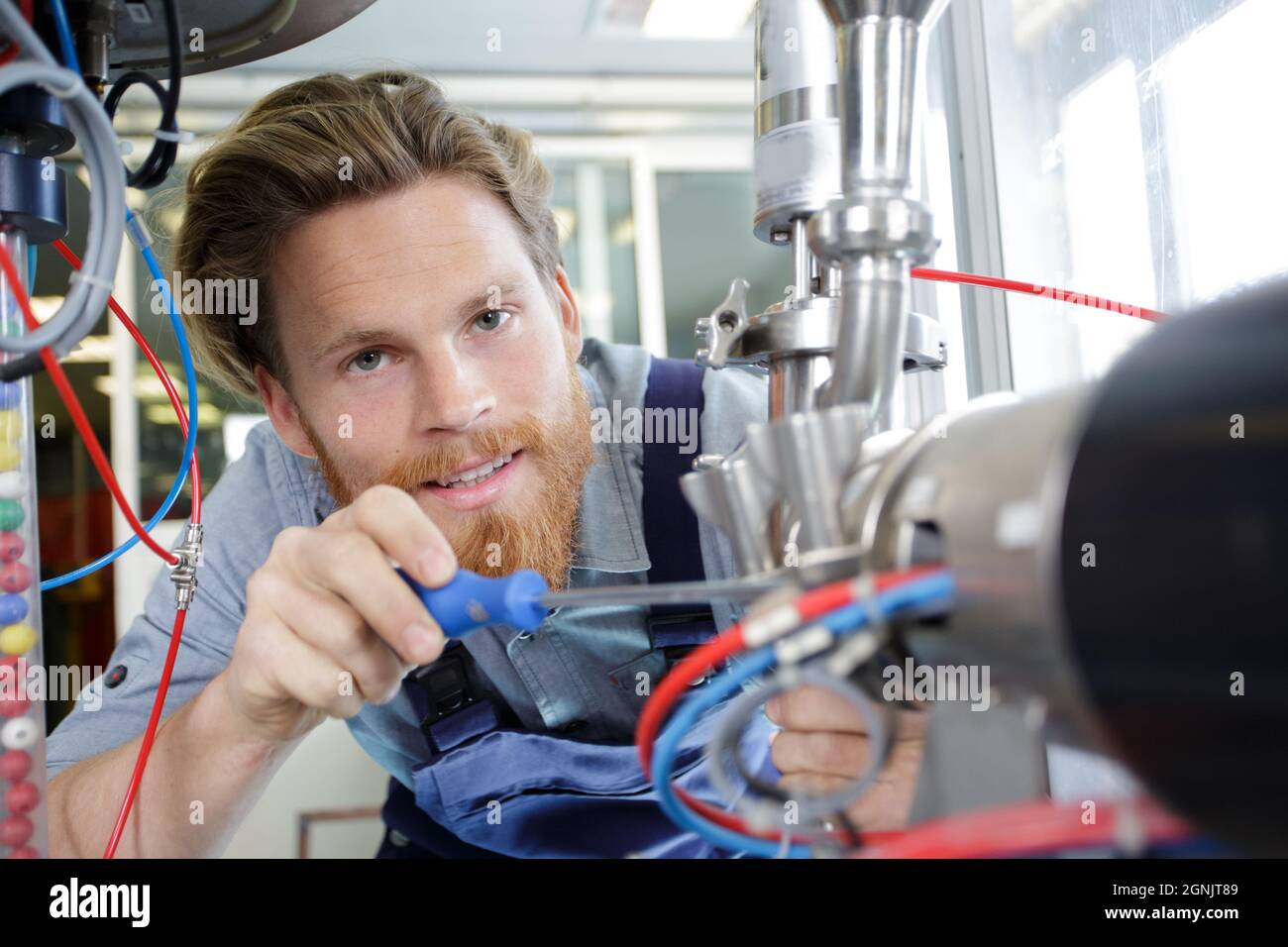 happy technician connects cables to electronic board Stock Photo - Alamy