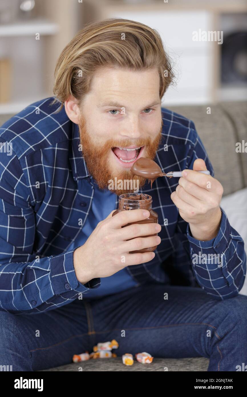 a man eating a chocolate Stock Photo - Alamy