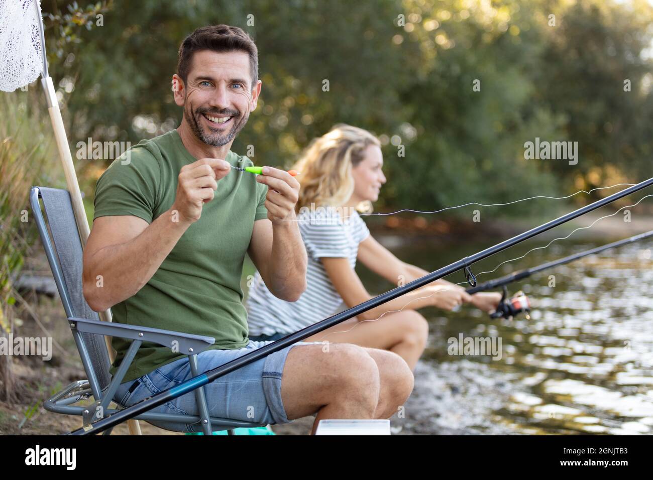 lovely young couple enjoying fishing Stock Photo - Alamy