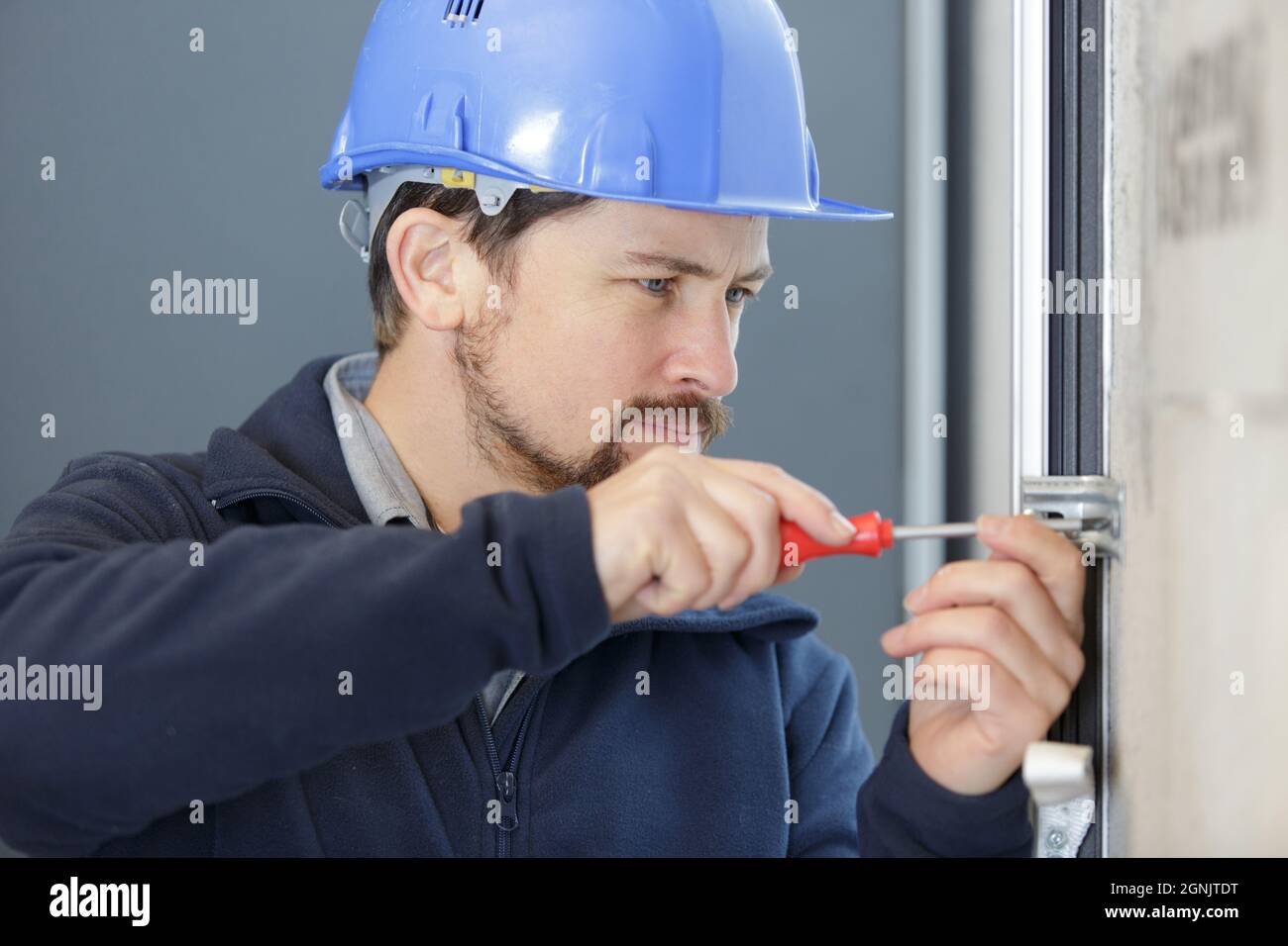construction worker installing window in house Stock Photo - Alamy
