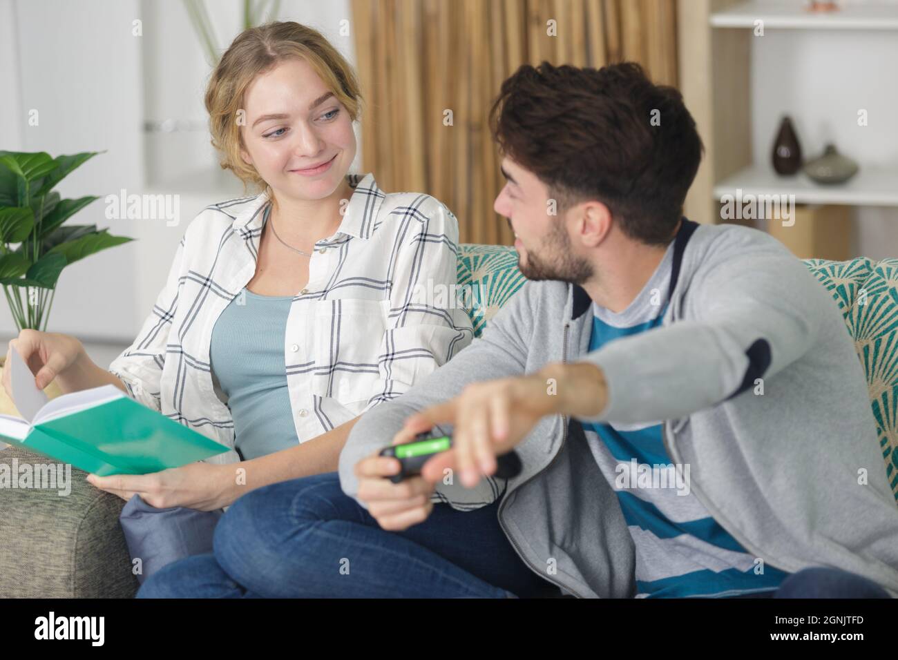 happy married couple spend time sitting on couch Stock Photo - Alamy