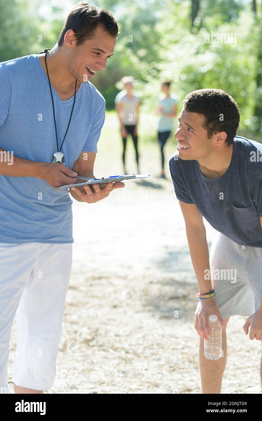 a coach talking to runner Stock Photo - Alamy