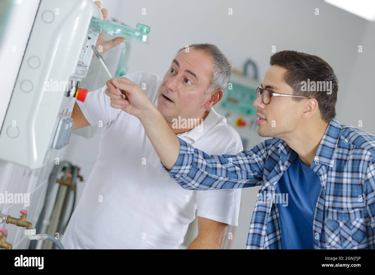 they are checking a machine Stock Photo - Alamy