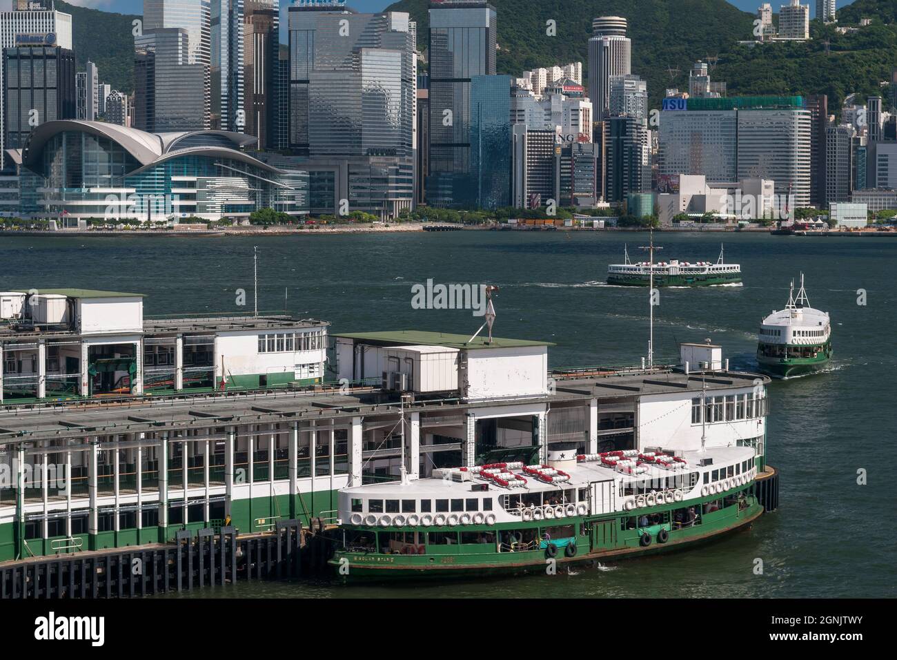 Star Ferries travel across Victoria Harbour between Tsim Sha Tsui pier in Kowloon and Hong Kong ...