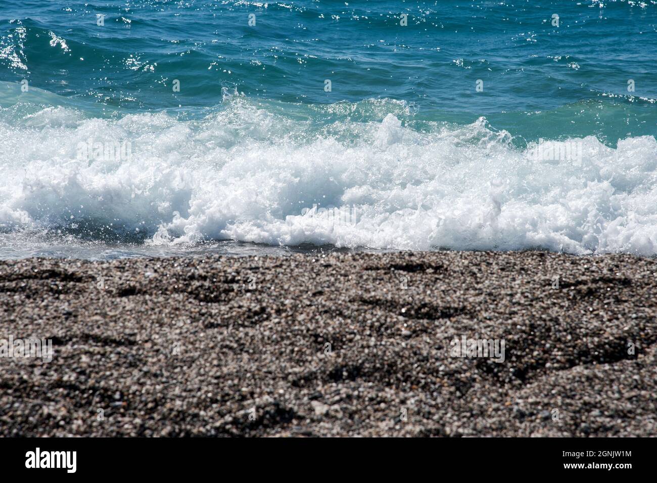 Waves splashing on beach sunny hi-res stock photography and images - Alamy