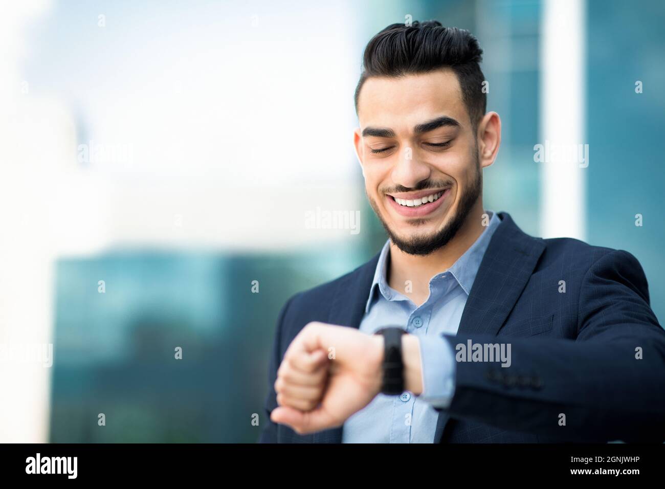 Rich middle-eastern man CEO checking time, having business meeting ...