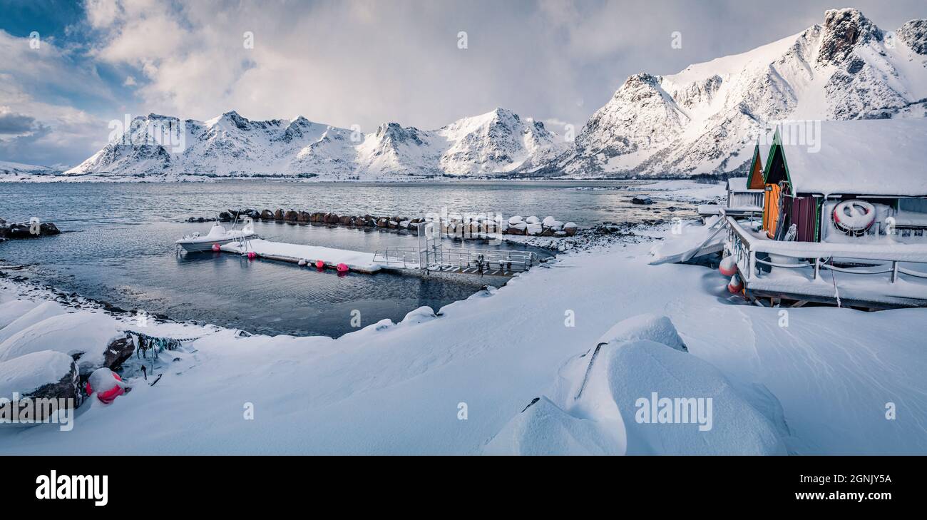 Dramatic morning view of Vestvagoy island with small pier, boat and ...