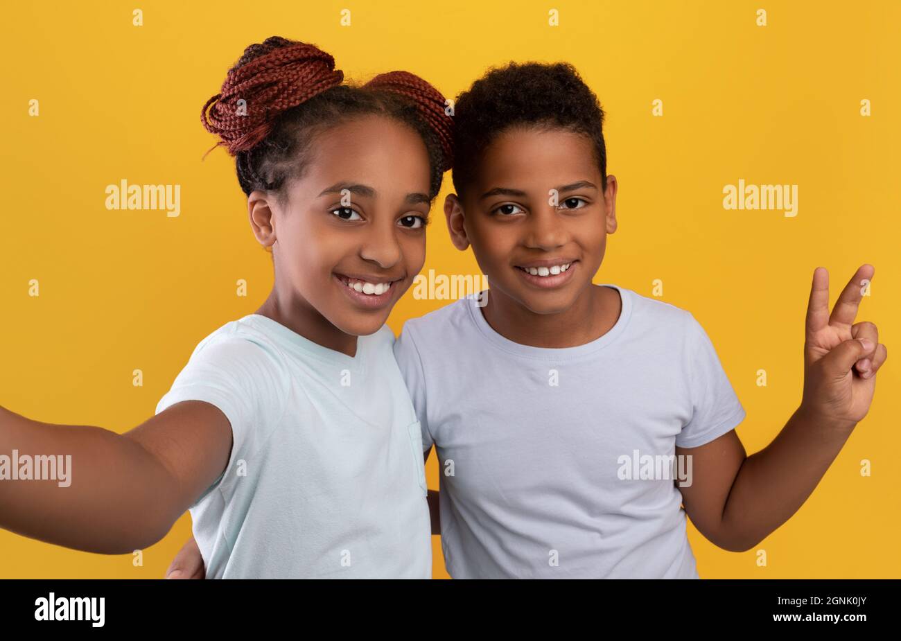 Positive black kids brother and sister taking selfie together Stock ...