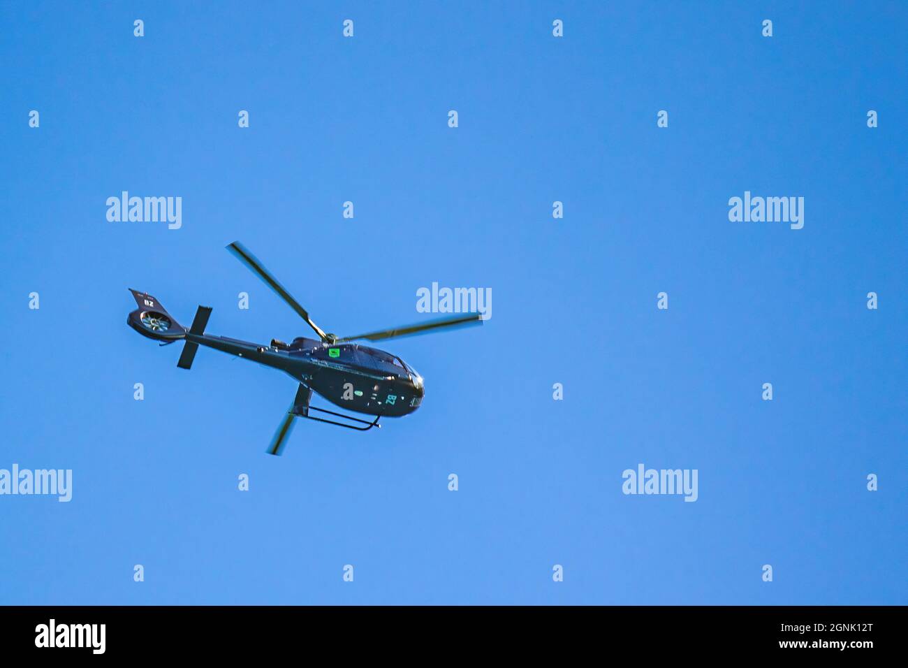 A helicopter flying under a clear blue sky during the 36th Americas Cup ...