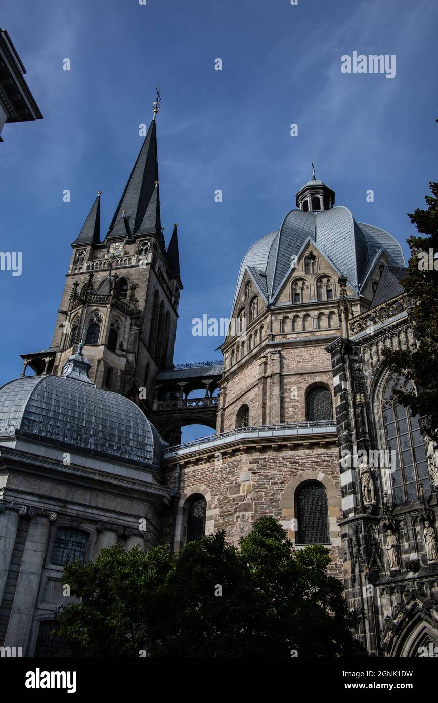 Aachen Cathedral with pointed towers and decorations under the blue sky ...