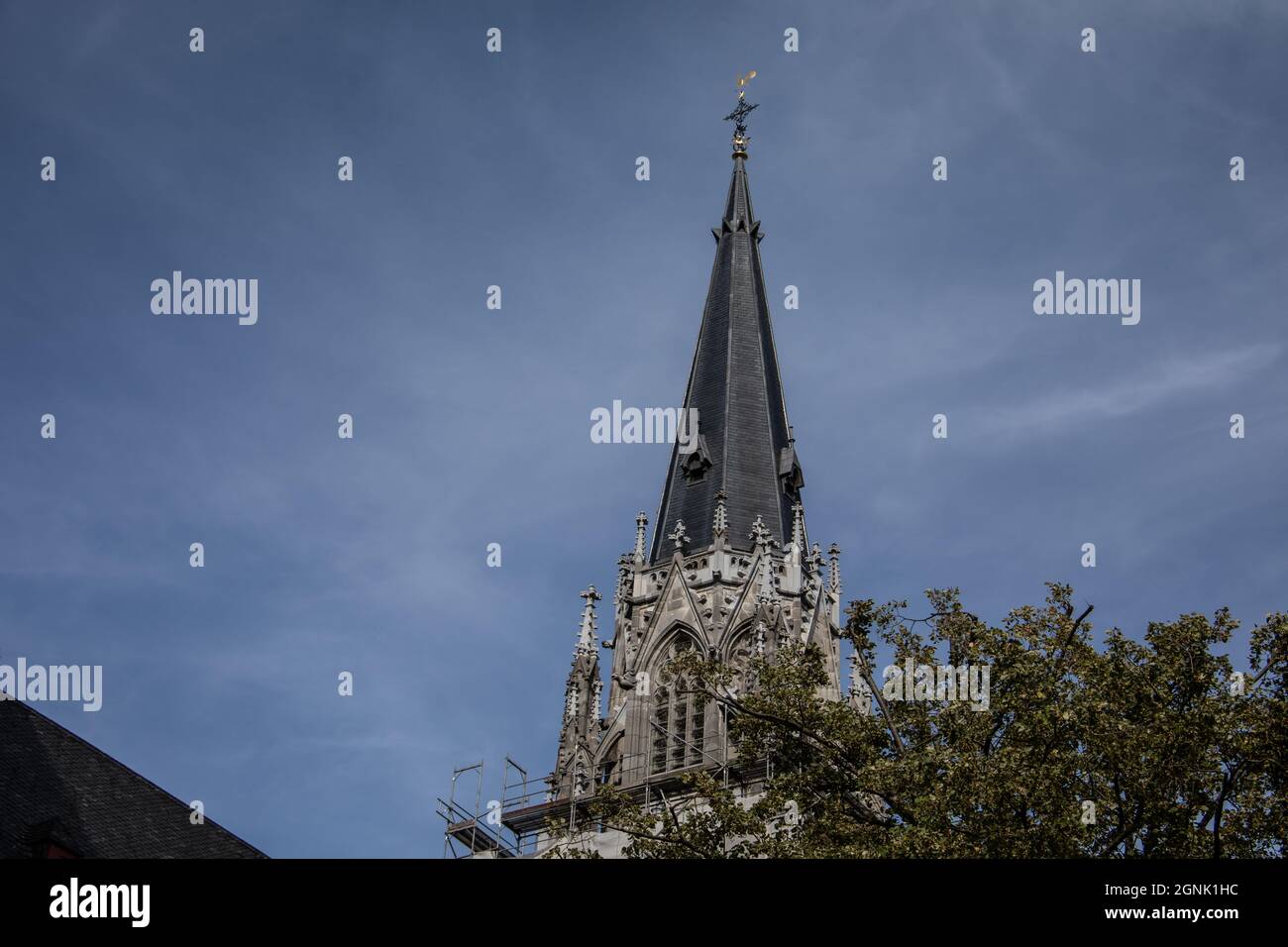 Aachen Cathedral with pointed towers and decorations under the blue sky ...