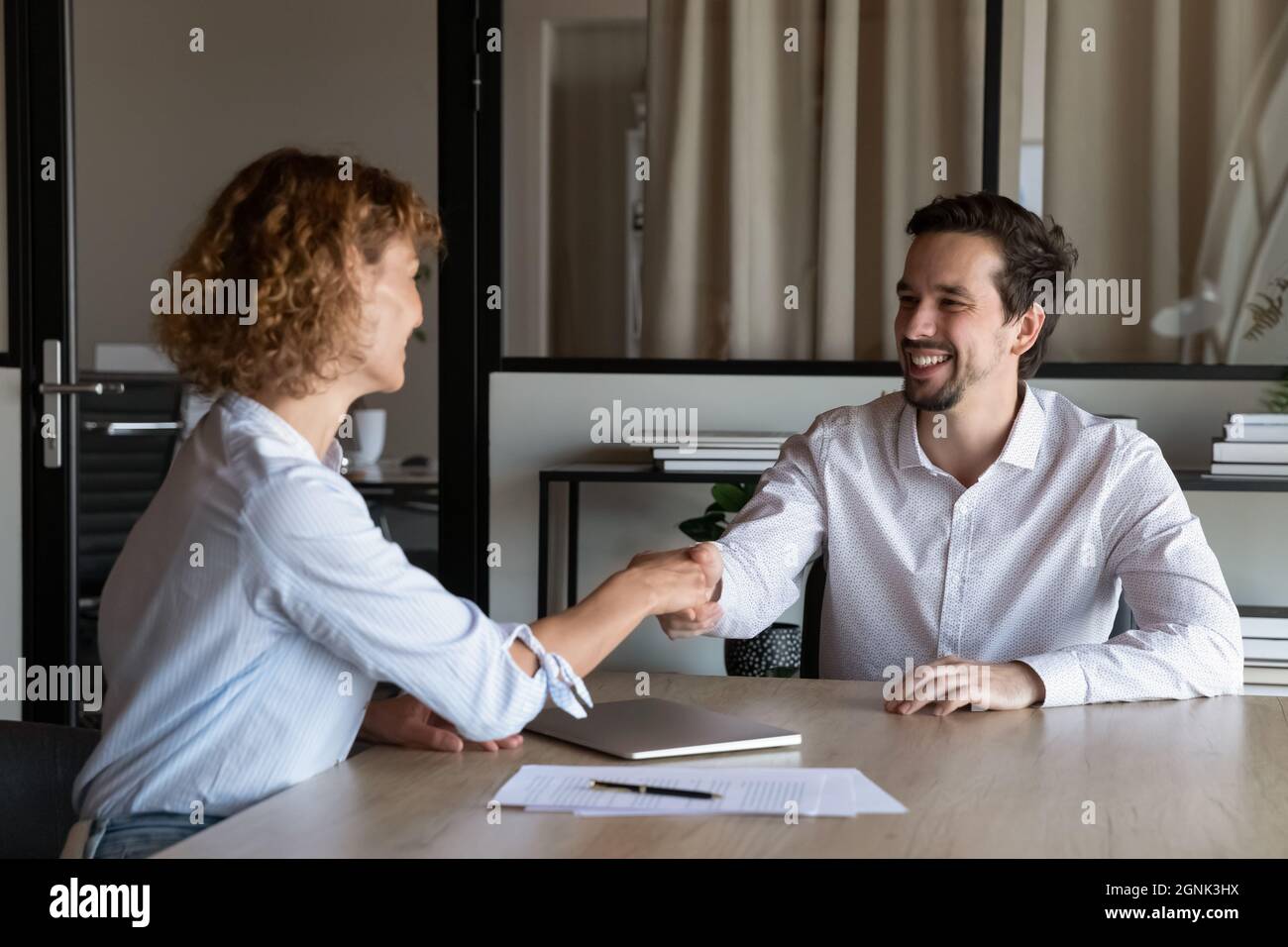 Happy employer hiring candidate after interview, congratulating on ...