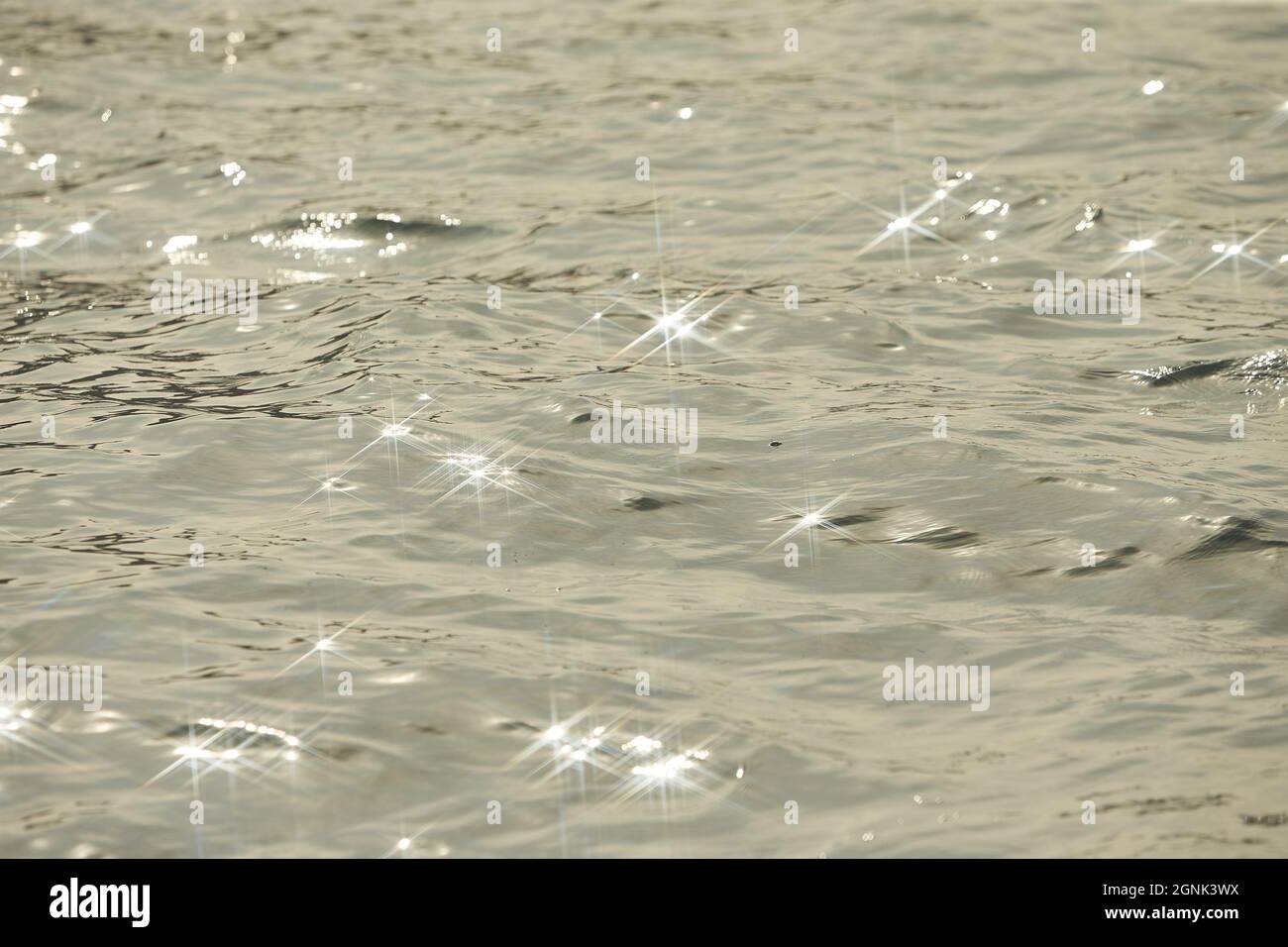 Detail of a sunlight reflecting in glittering sea. sparkler in water ...