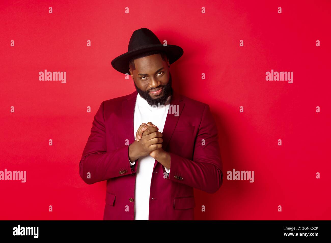 Cunning black man having an idea, smiling devious and rubbing hands ...