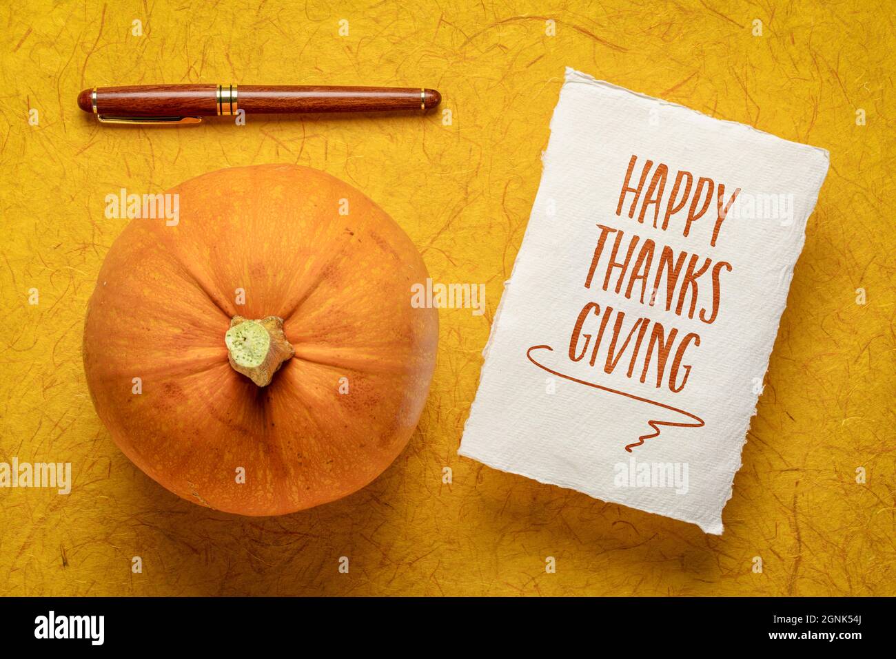 Happy Thanksgiving - handwriting on white Khadi paper with a pumpkin ...