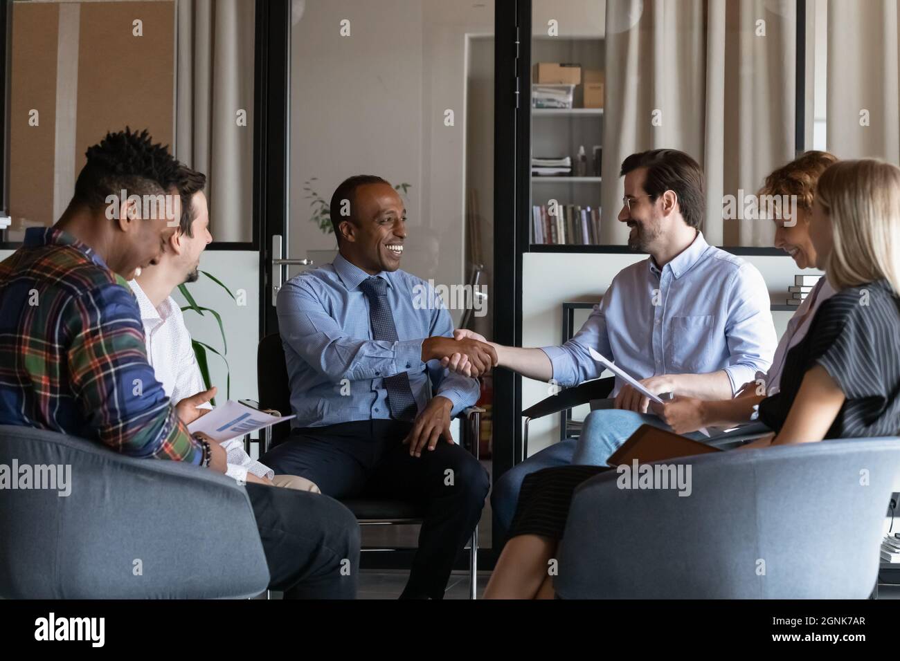 Happy African American boss shaking hands with young employee Stock ...