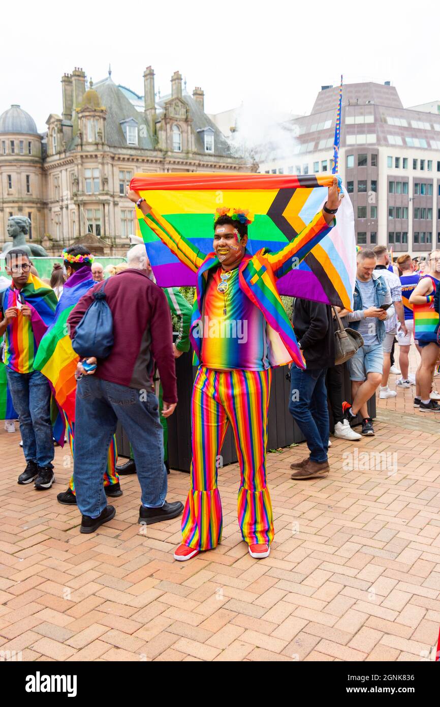 young Asian asian man poses with rainbow flag at Birmingham Pride ...