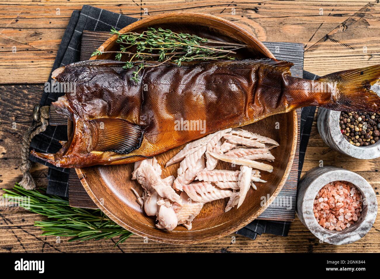 Fillet of Hot smoked fish pike perch or zander in a wooden plate with ...
