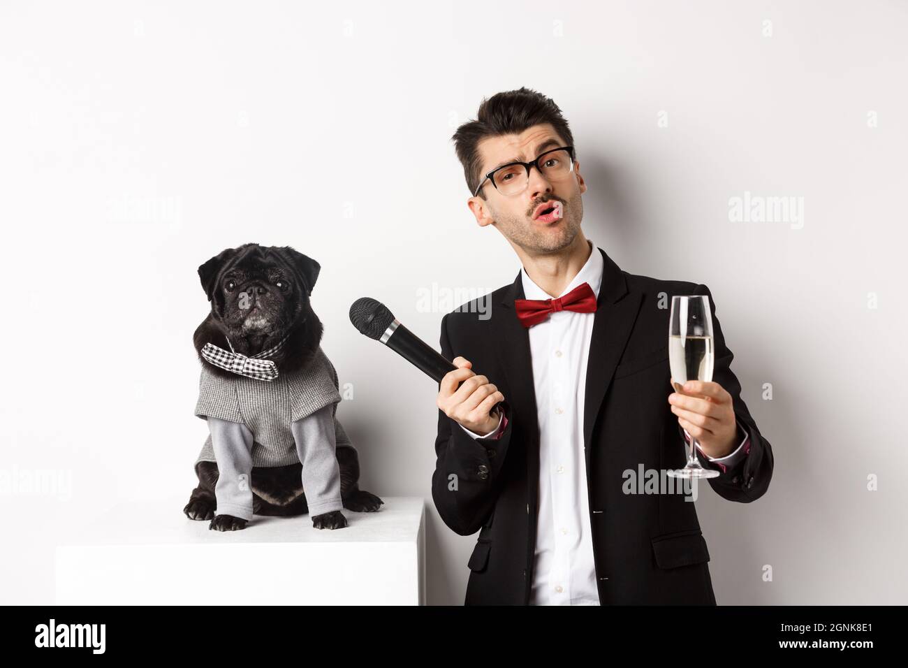 Handsome fancy man in glasses, raising glass of champagne and giving ...