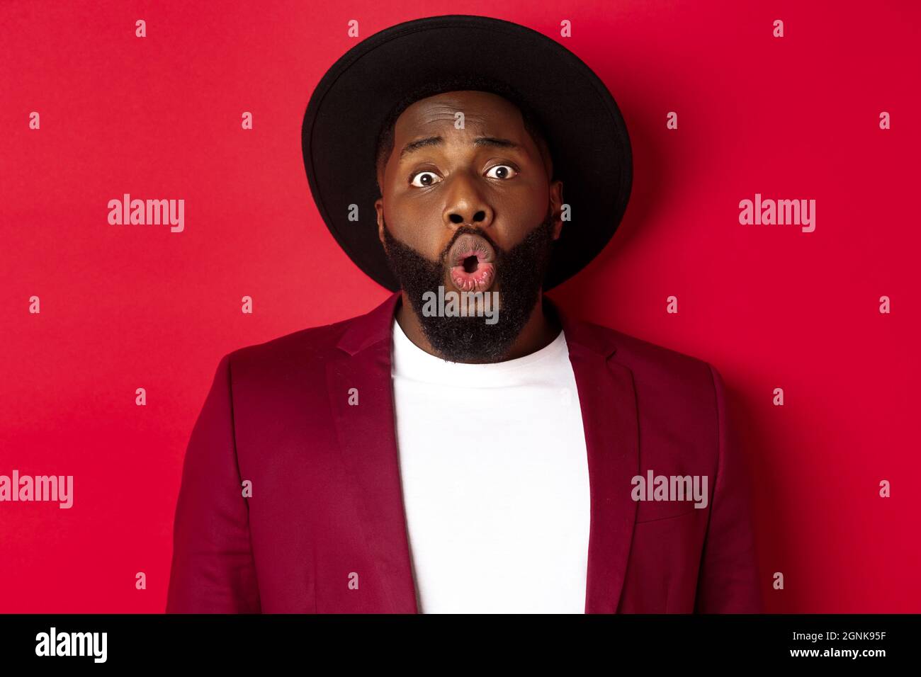 Close-up of surprised Black man staring at camera with wonder, standing ...