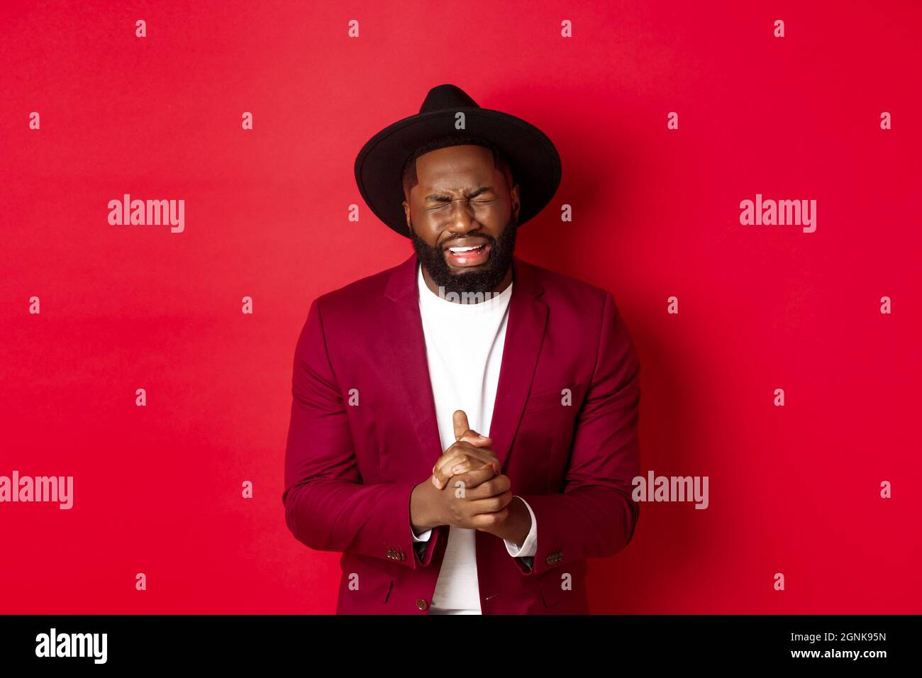 Miserable and heartbroken Black man crying, begging for help, holding ...