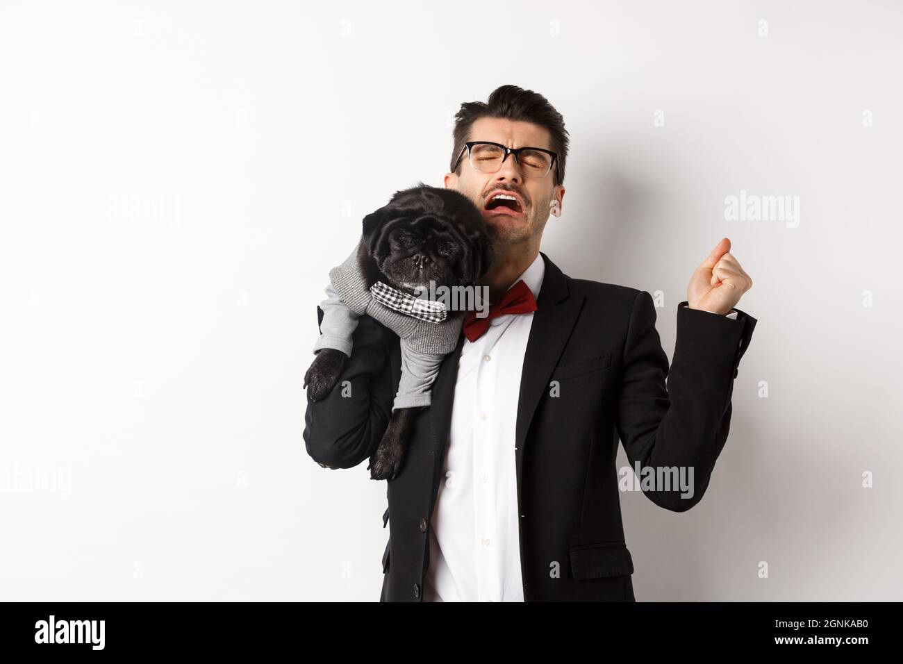 Sad man in suit, holding cute small dog on shoulder and crying with ...
