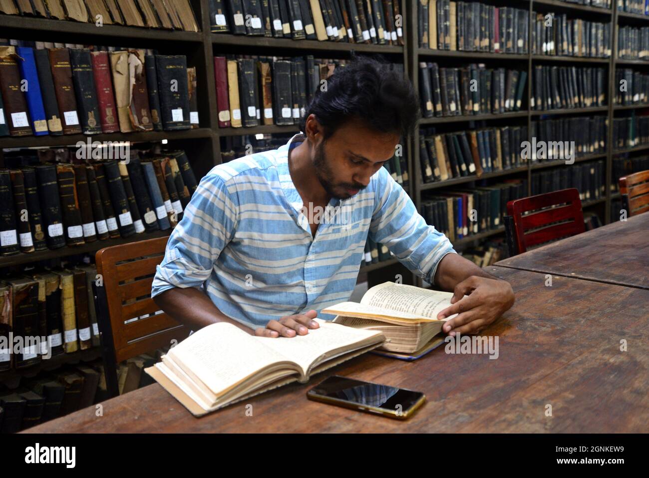 Students reads book in the central library of Dhaka University after ...