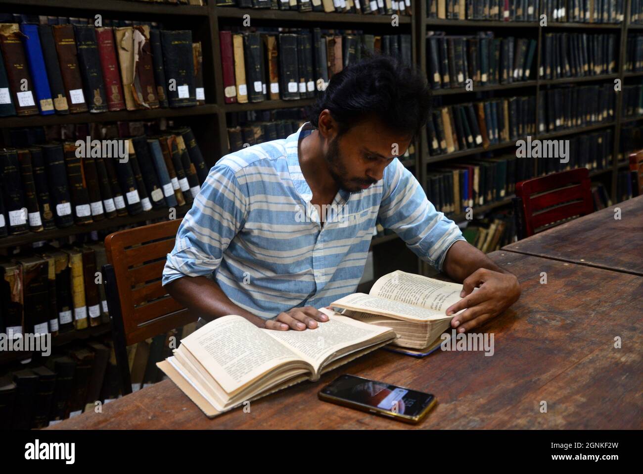 Students reads book in the central library of Dhaka University after ...