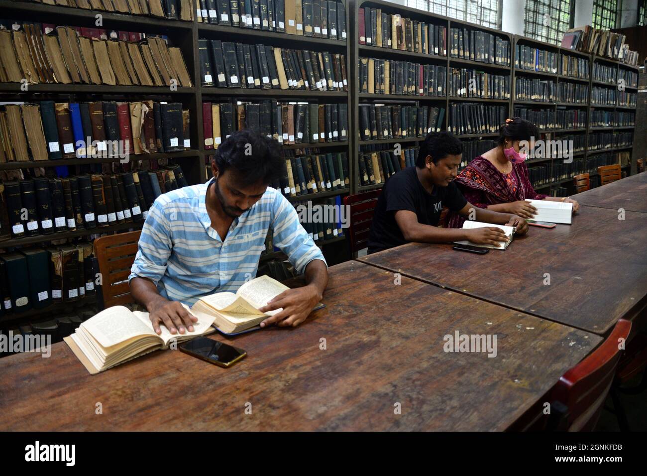 Students reads book in the central library of Dhaka University after ...