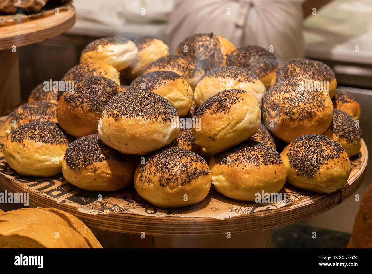 fresh buns with poppy seeds on a wooden tray. bakery in turkey, small ...