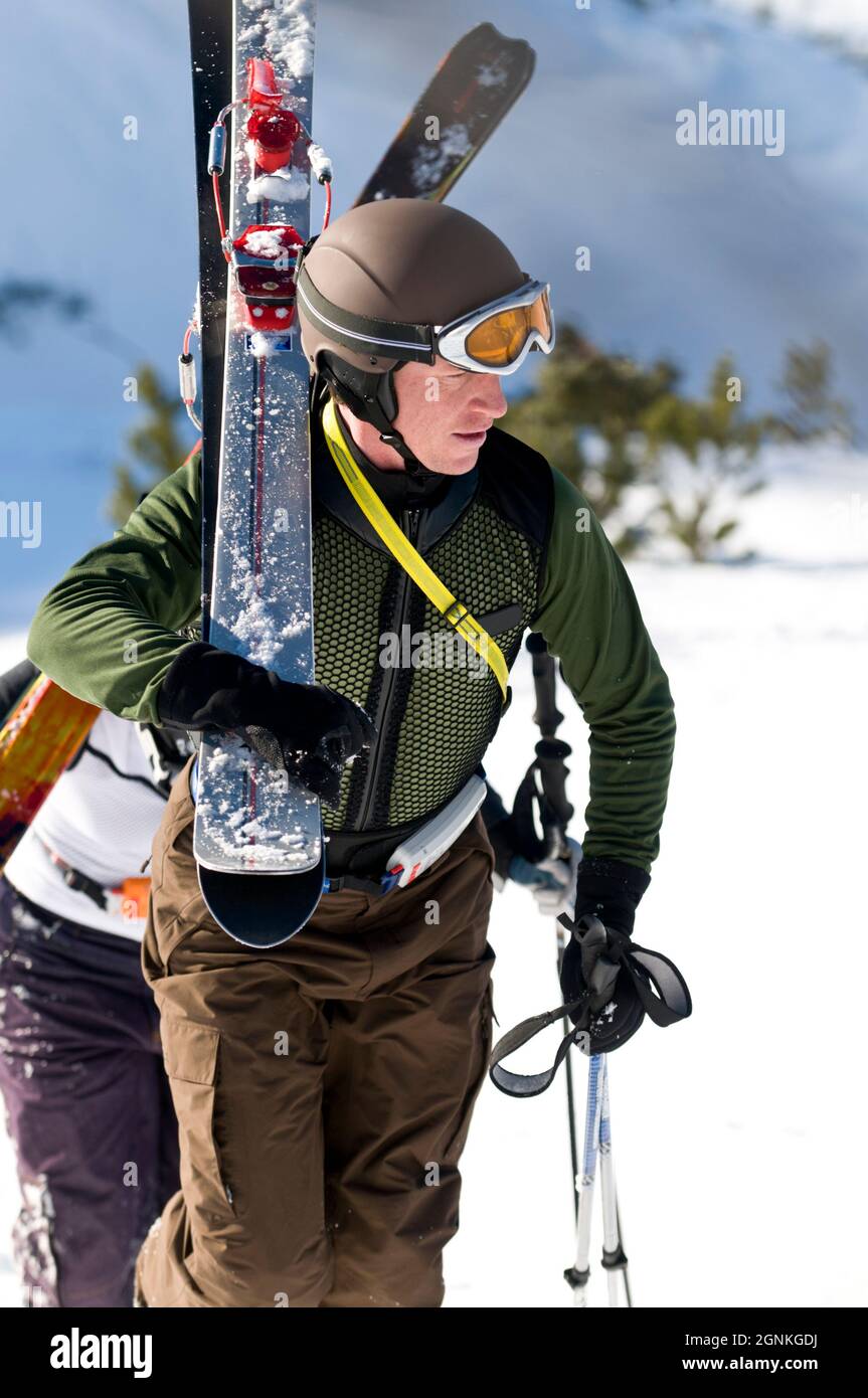 Freeskier skiing in backcountry with safety equipment Stock Photo - Alamy