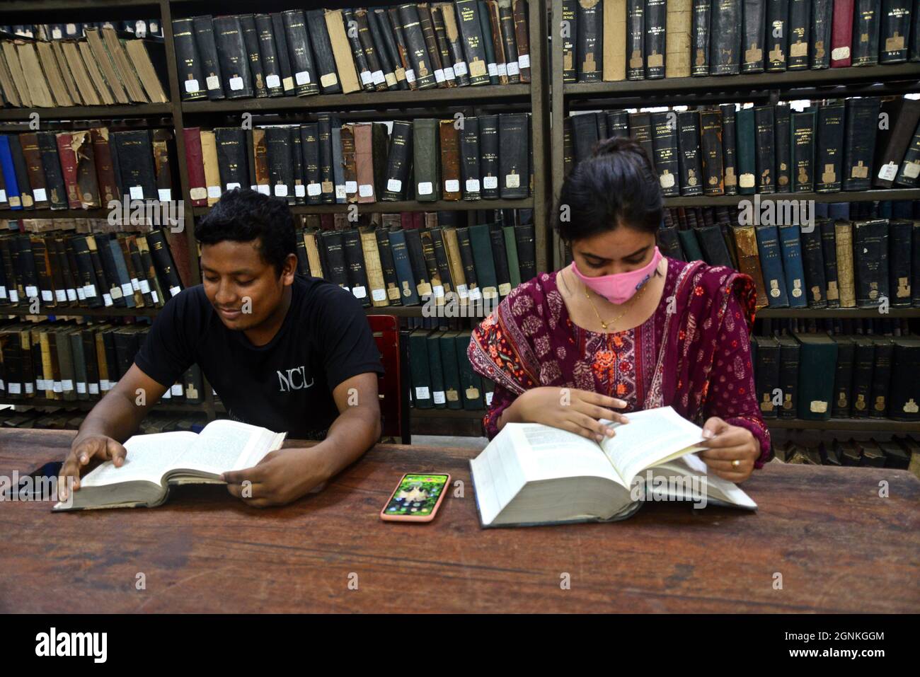 Students reads book in the central library of Dhaka University after ...