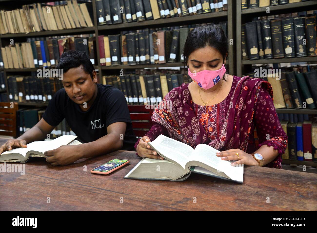 Students reads book in the central library of Dhaka University after ...