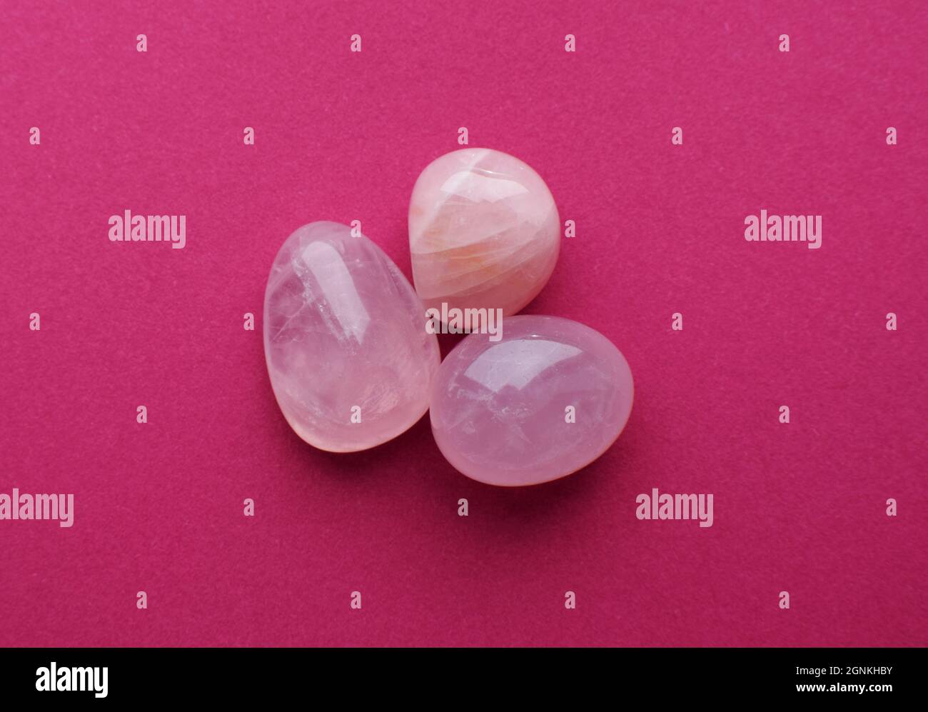 Crystals of rose quartz on a bright pink background. Beautiful semi ...