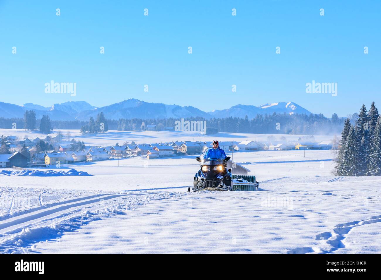 Preparation of cc-track with a skidoo and tracking Stock Photo - Alamy