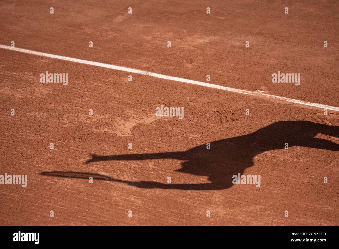 Shadow of tennis player serving at the French Open 2021 tennis ...
