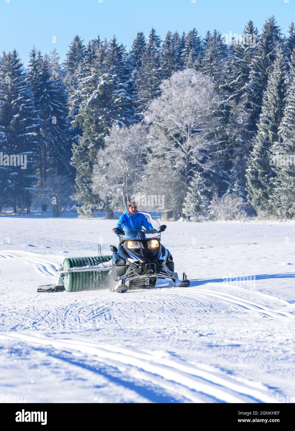 Preparation of cc-track with a skidoo and tracking Stock Photo - Alamy
