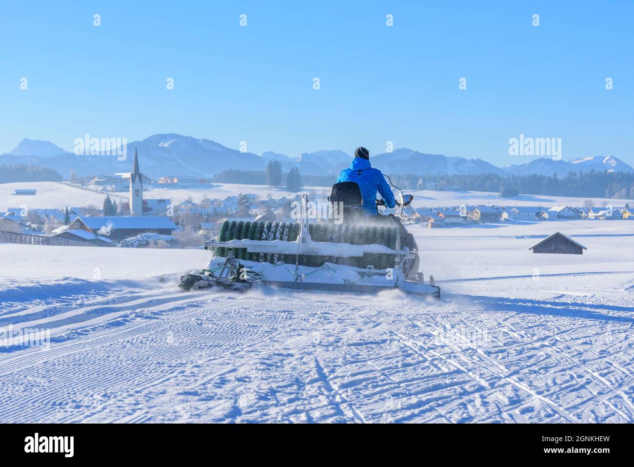 Preparation of cc-track with a skidoo and tracking Stock Photo - Alamy