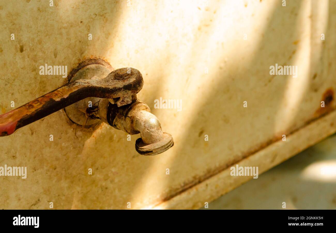 Bronze old iron water tap, without water, closed outdoor, on the white ...