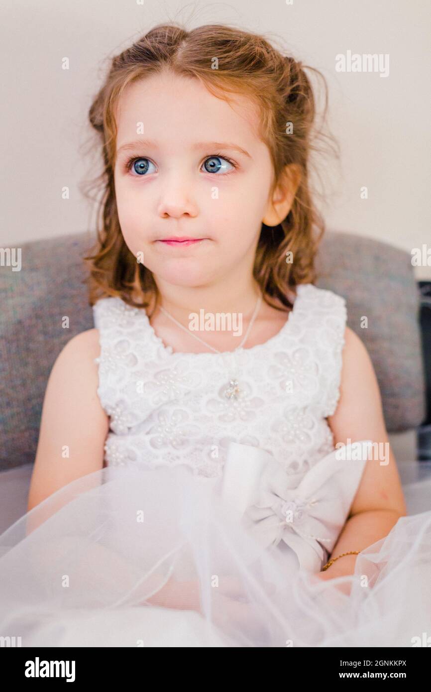 A cute caucasian kid with blue eyes wearing a white princess dress Stock Photo - Alamy