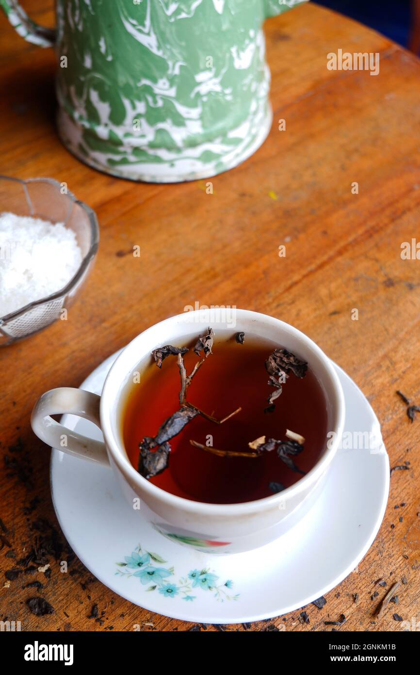 A vertical shot of a cup of black tea on a wooden table Stock Photo - Alamy