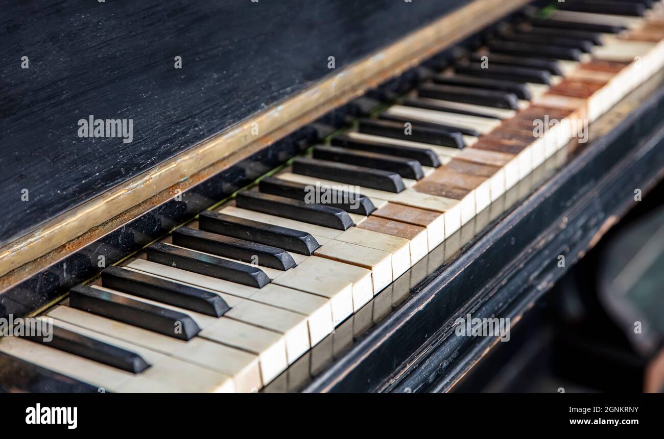 Classic old piano keys. The keyboard of a very old abandoned piano is ...