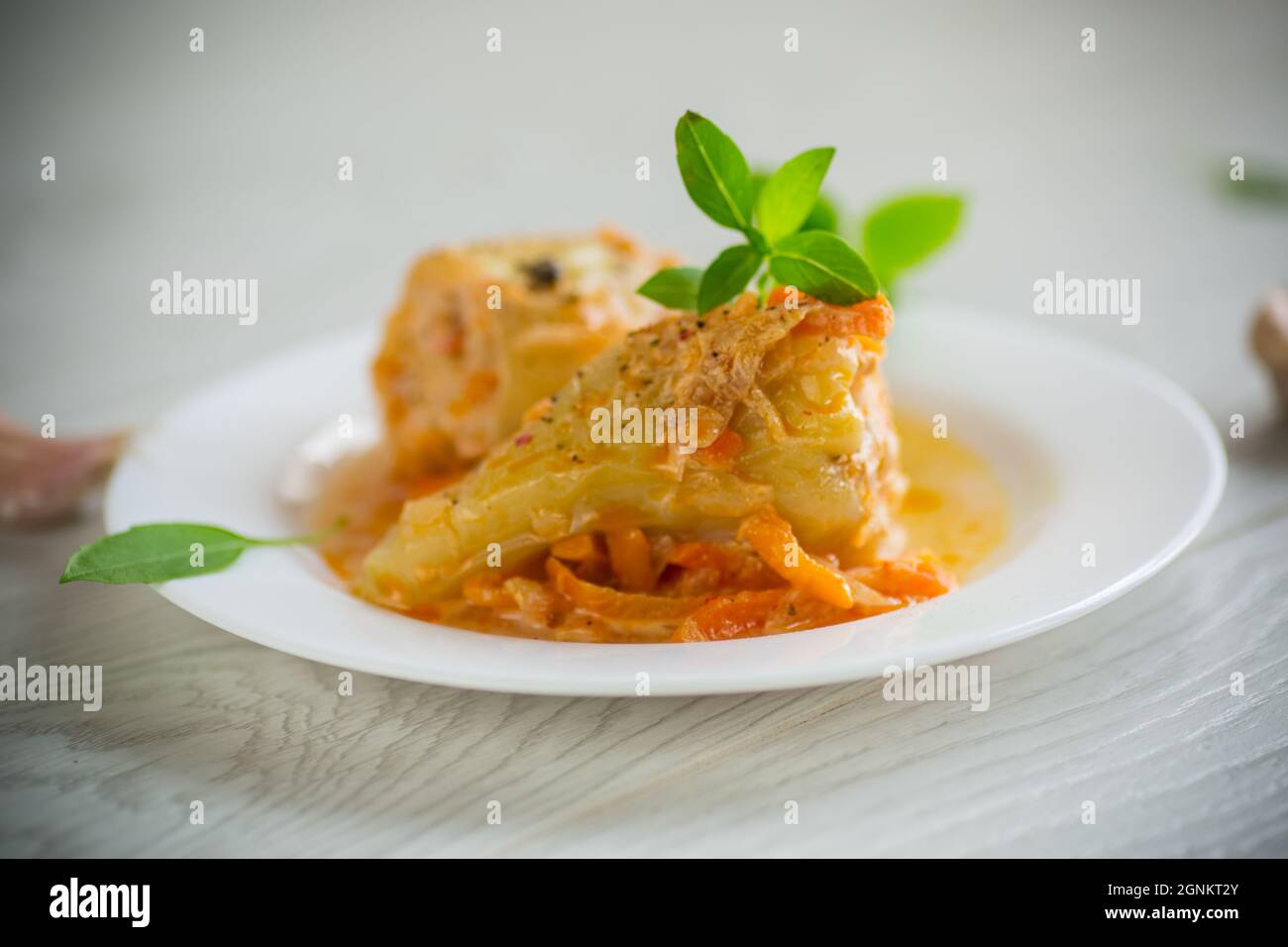 stewed in gravy stuffed peppers in a plate on a wooden table Stock ...