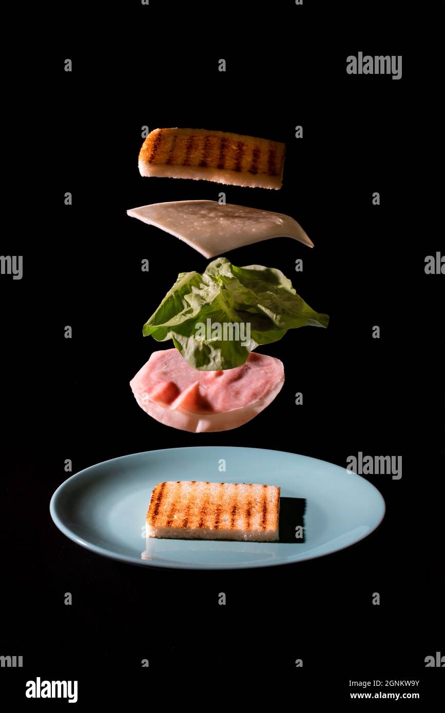 Construction of a sandwich, with a slice of bread on a plate, and in ...