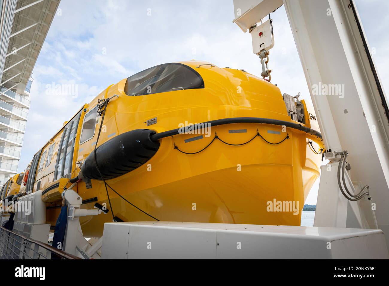 Large yellow lifeboats on the side of a cruise ship Stock Photo - Alamy