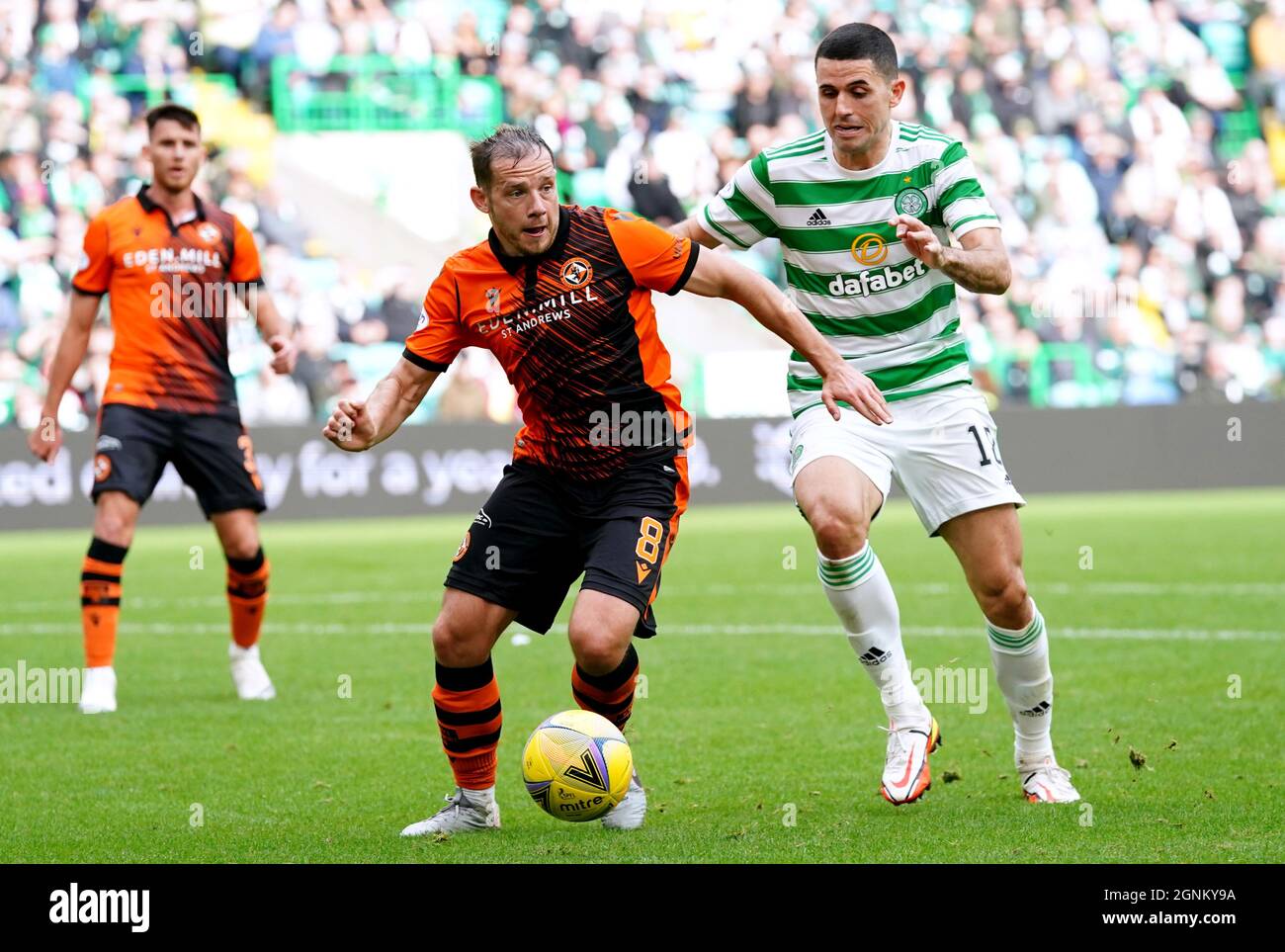 Dundee United's Peter Pawlett (left) and Celtic's Tom Rogic battle for ...